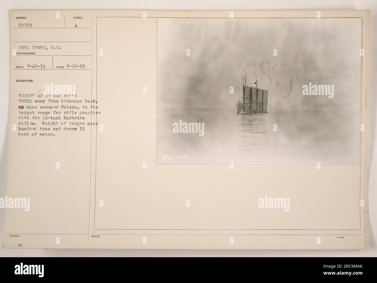 Target being towed away from Ordnance Dock by mine sweeper Falcon for ...