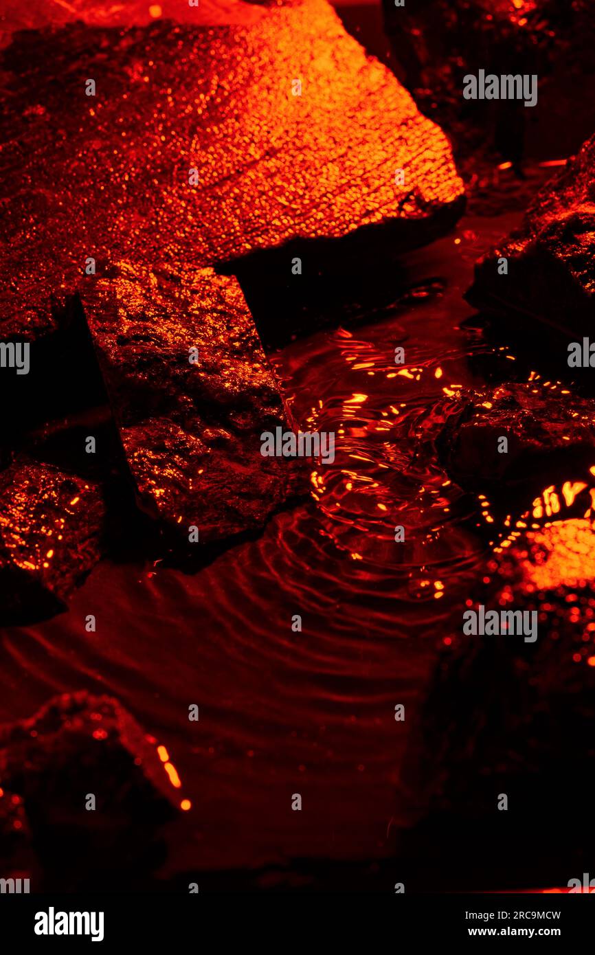 Stones and water illuminated by colored light Stock Photo - Alamy