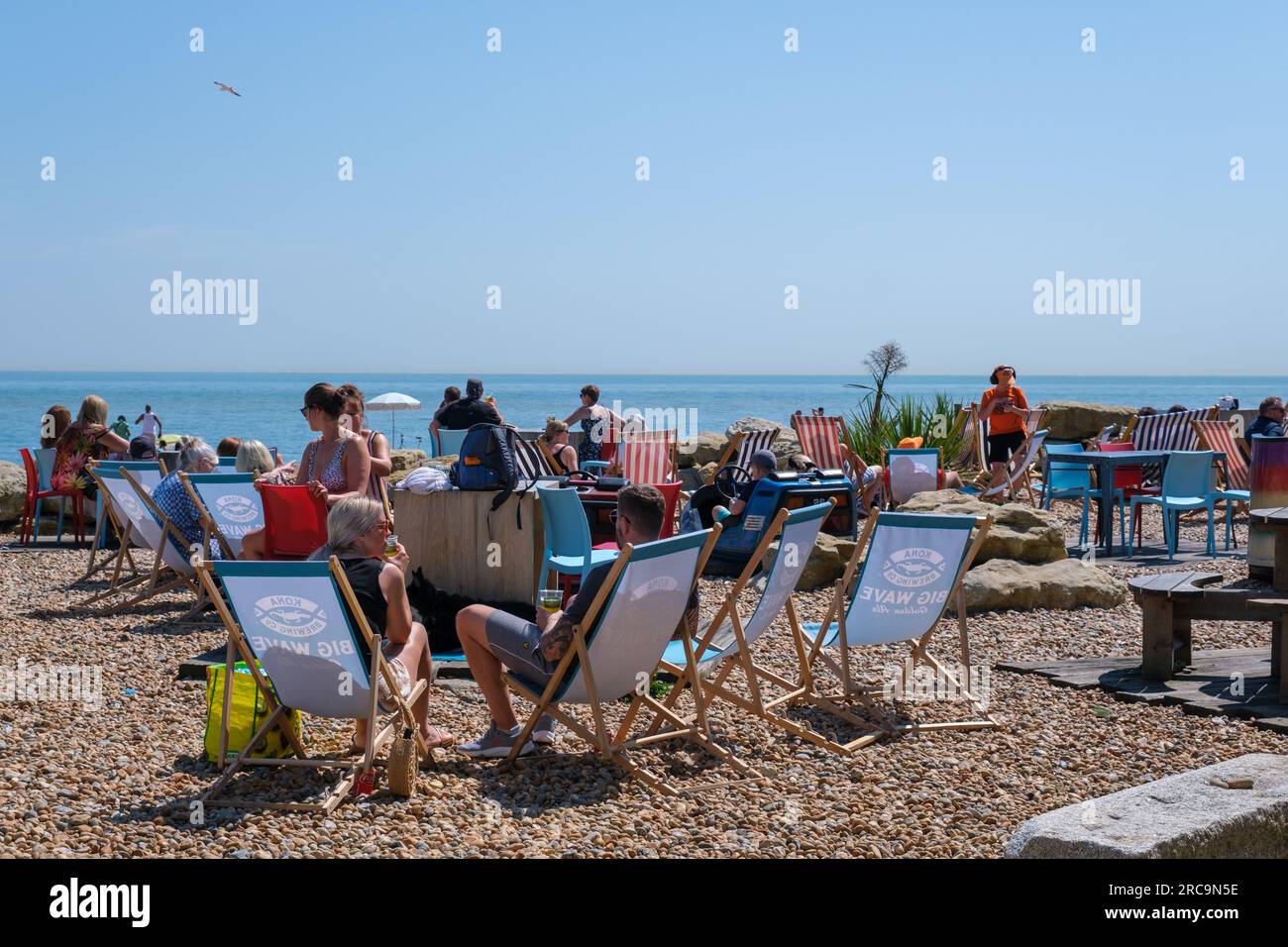 Folkestone, UK - 9 July 2023: People on Sunny sands beach enjoying the ...