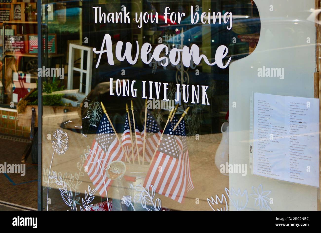 Antiques and junk shop window with American flags and writing Thank you ...