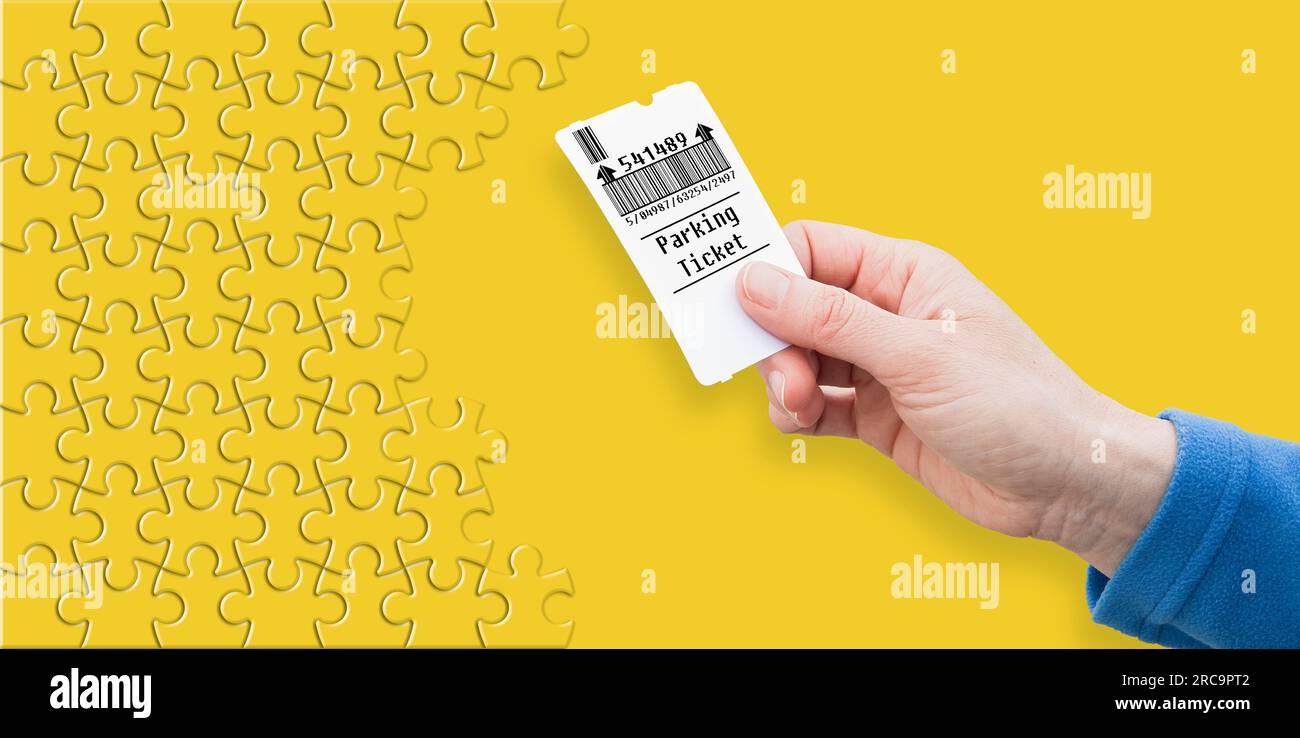 Female hand holds a parking ticket - parking payment concept on solid ...