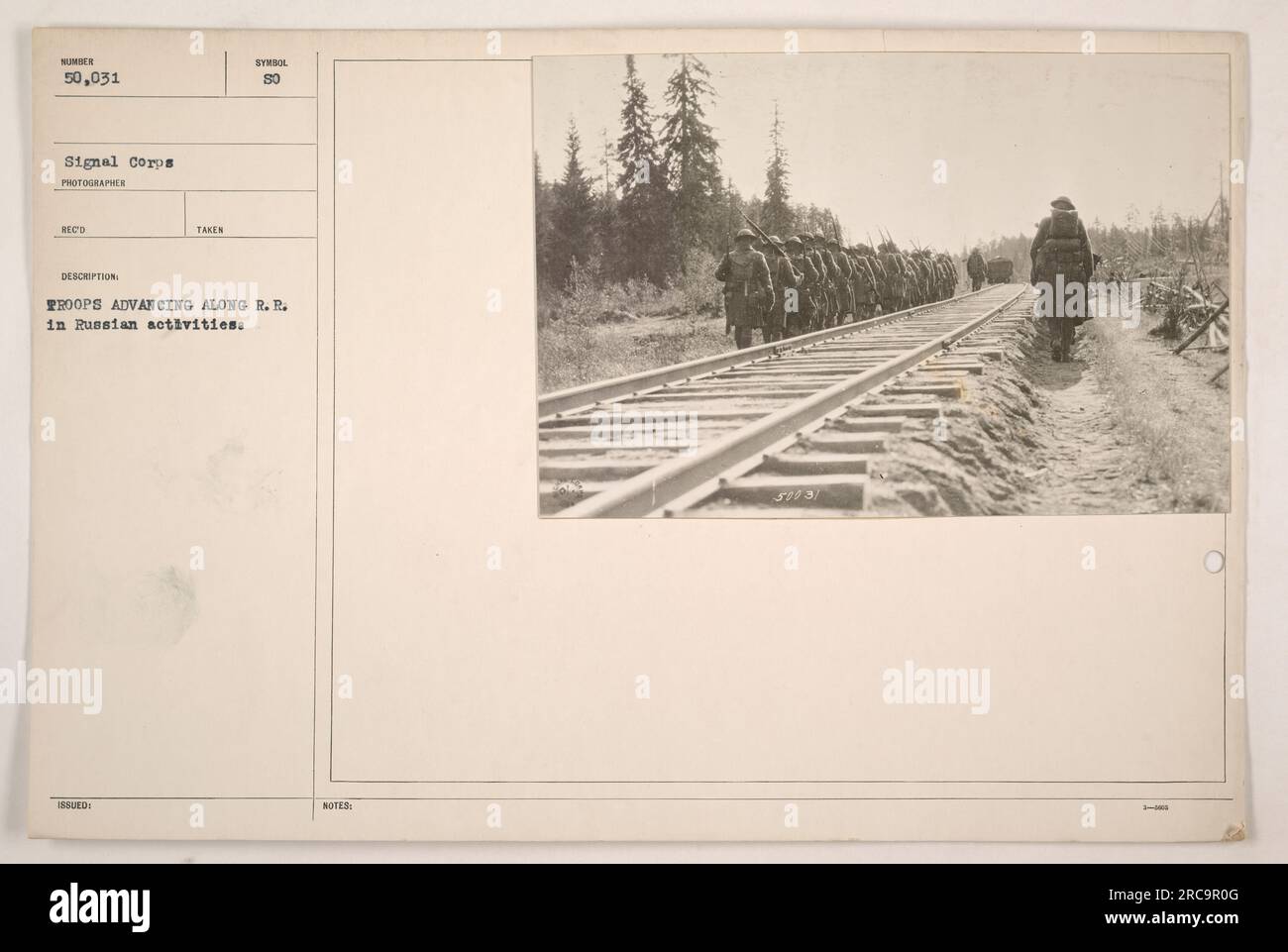 American troops seen advancing along a railroad during military ...