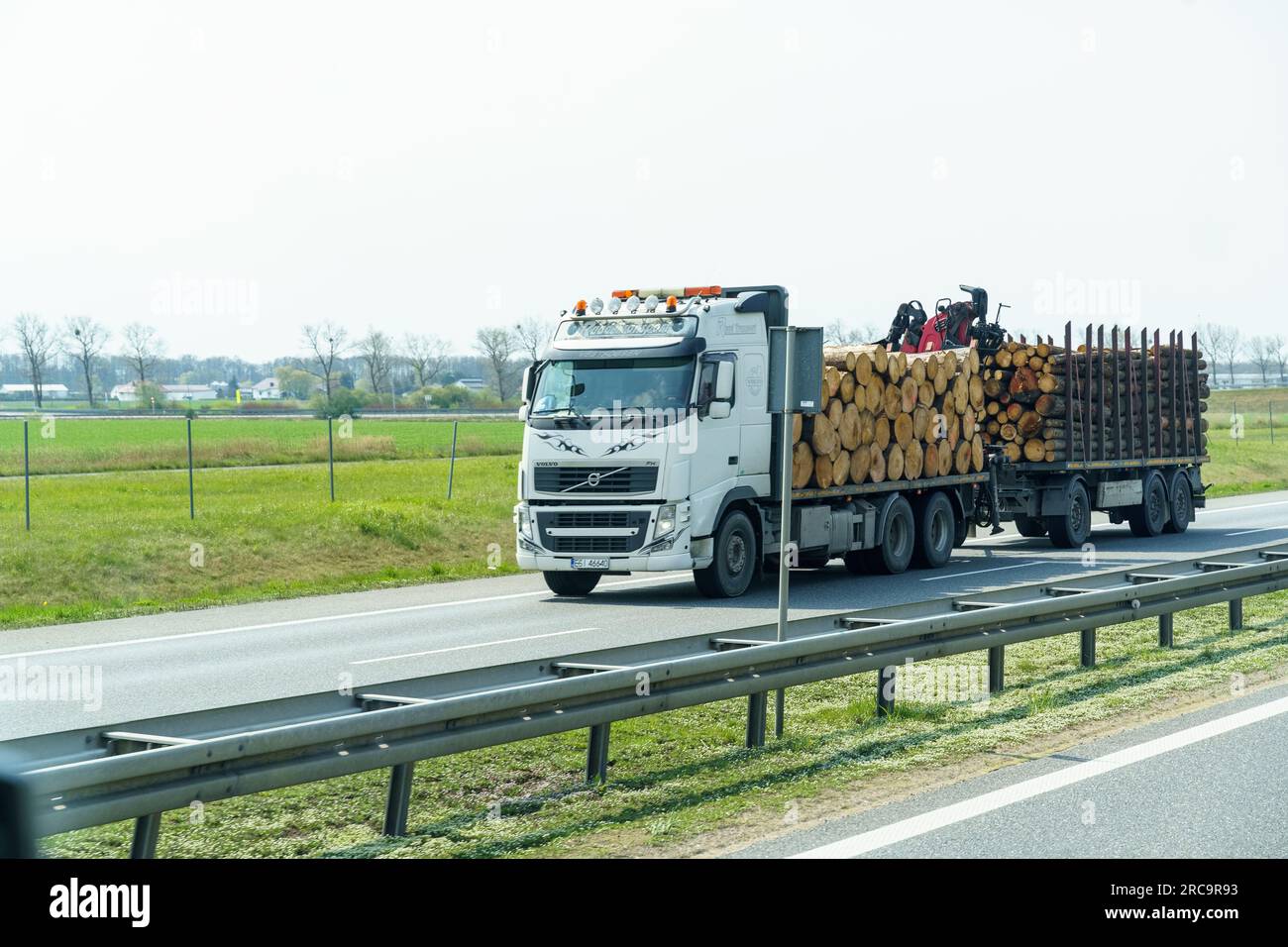 Dresden, Germany - April 24, 2023: Timber truck transports cut trees from the forest along the ...