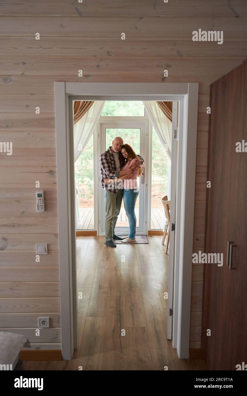Loving woman and male hugging one another in cottage Stock Photo - Alamy