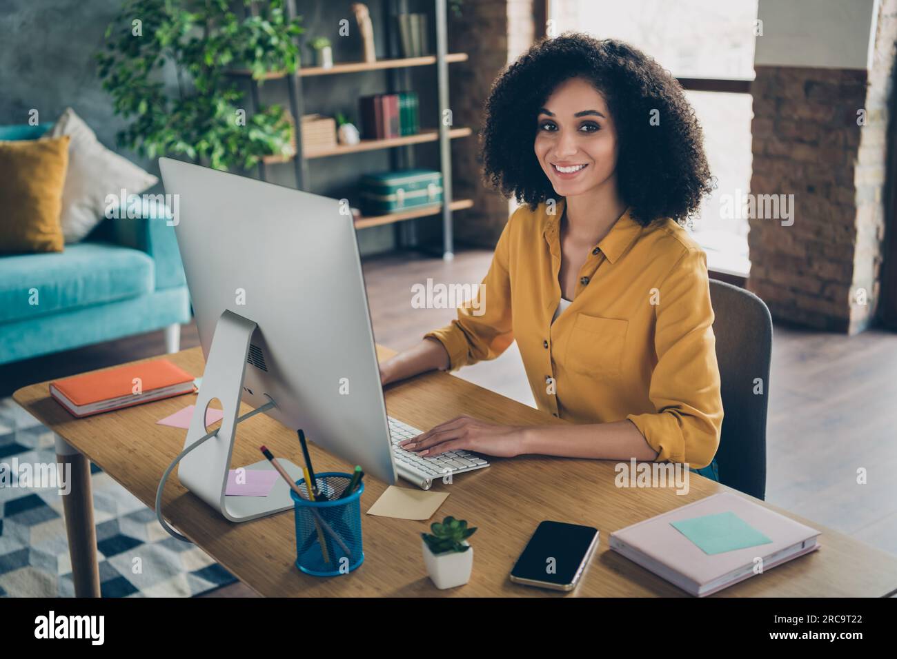 Photo of cheerful pretty lady realtor wear shirt smiling writing emails ...