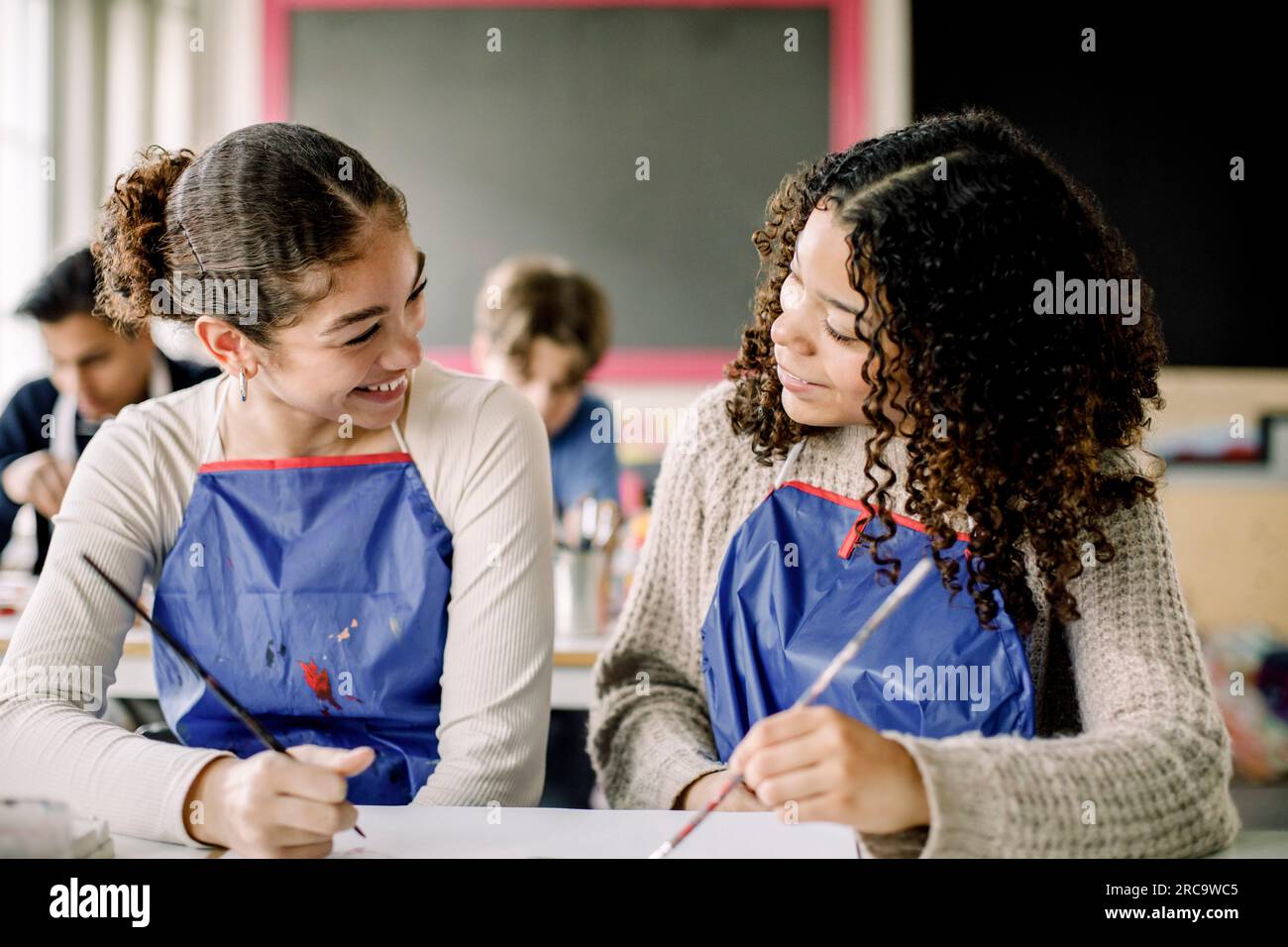 Smiling teenage girls talking class hi-res stock photography and images ...