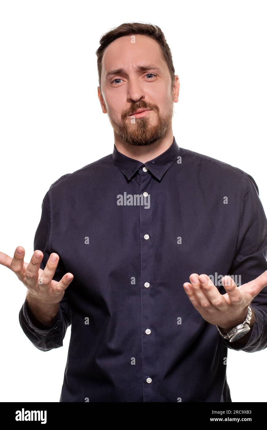 Portrait of a handsome, unshaven man, dressed in a dark blue shirt ...