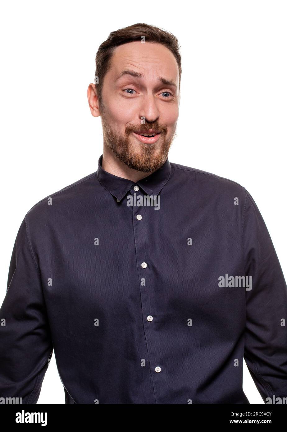 Portrait of a handsome, unshaven man, dressed in a dark blue shirt ...