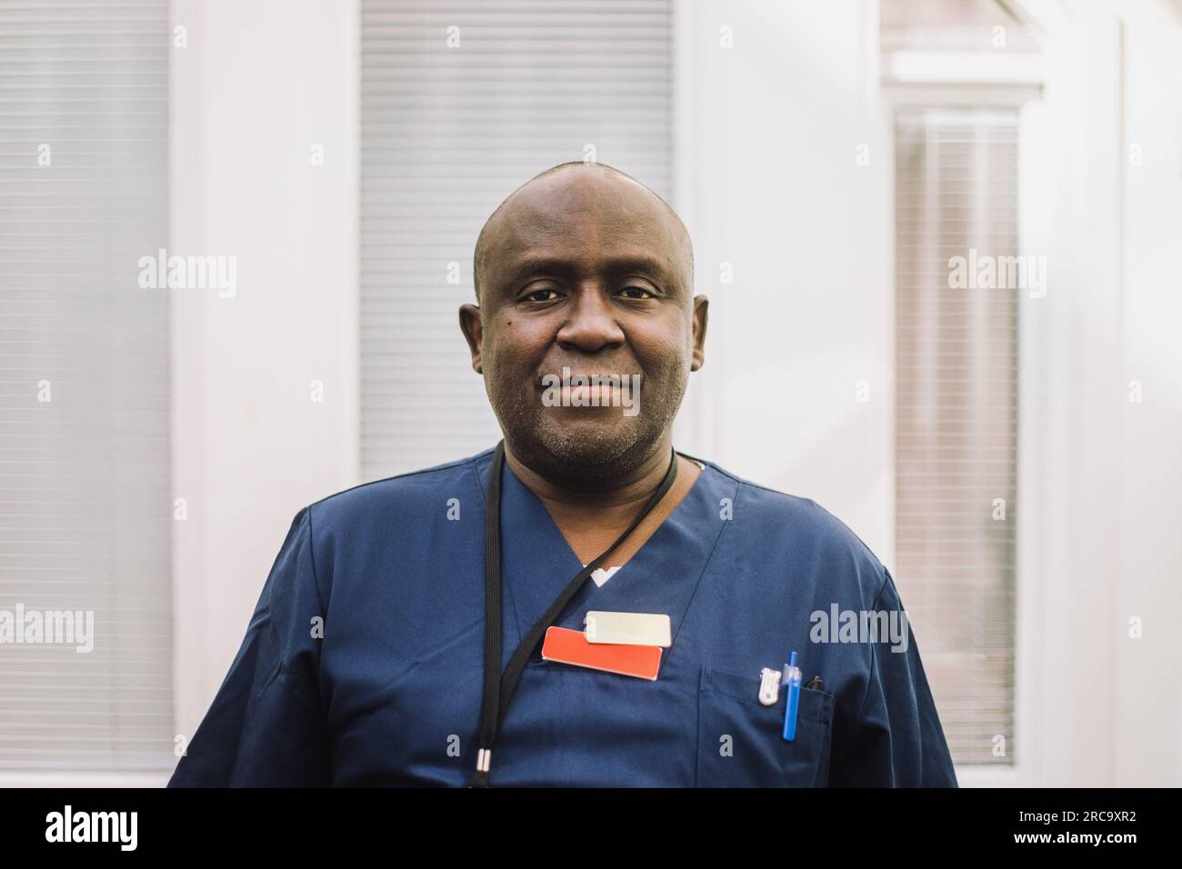 Portrait of mature male doctor with shaved head at hospital Stock Photo ...