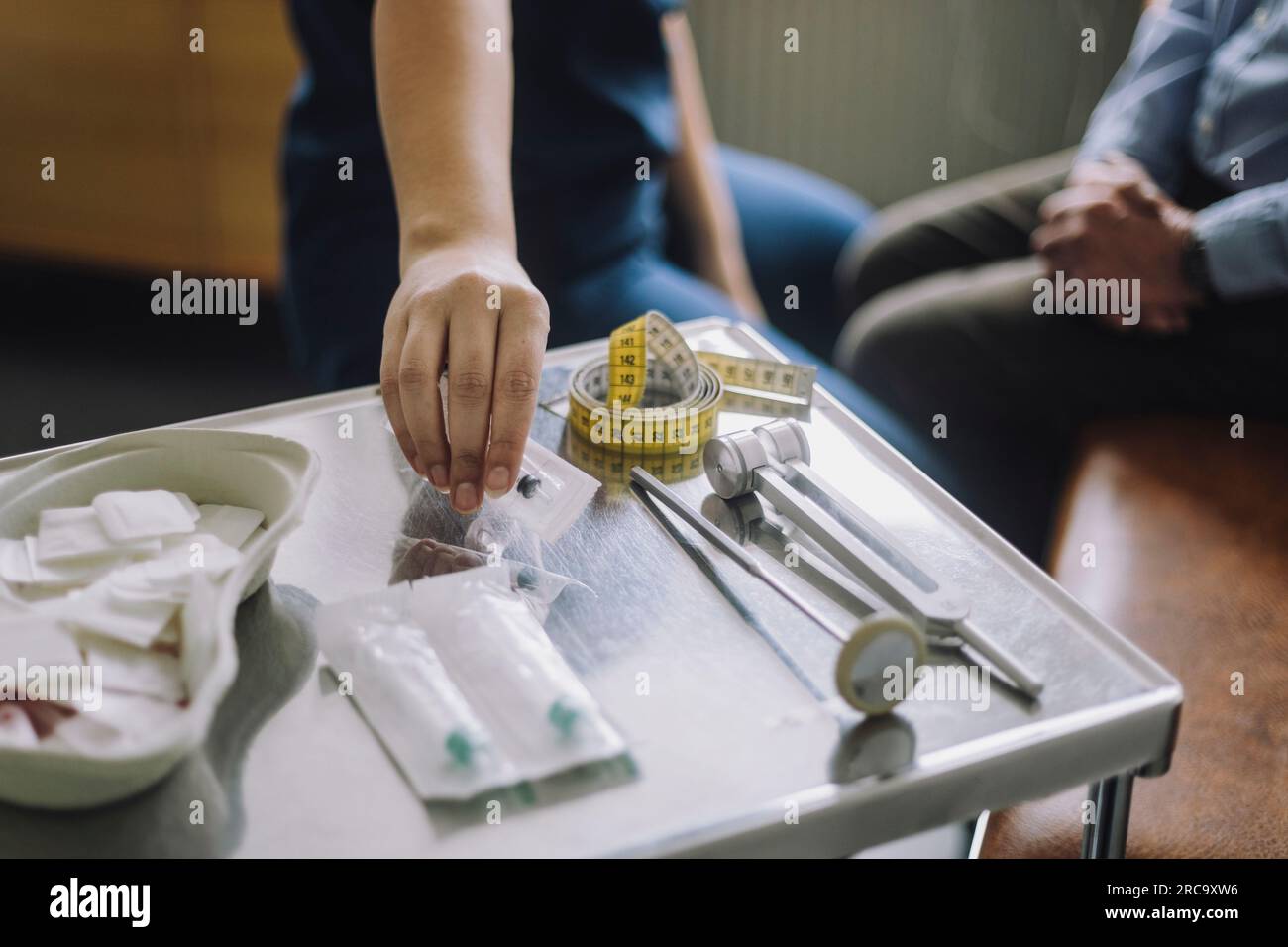 Hand of female nurse picking up injection from trolley at hospital ...