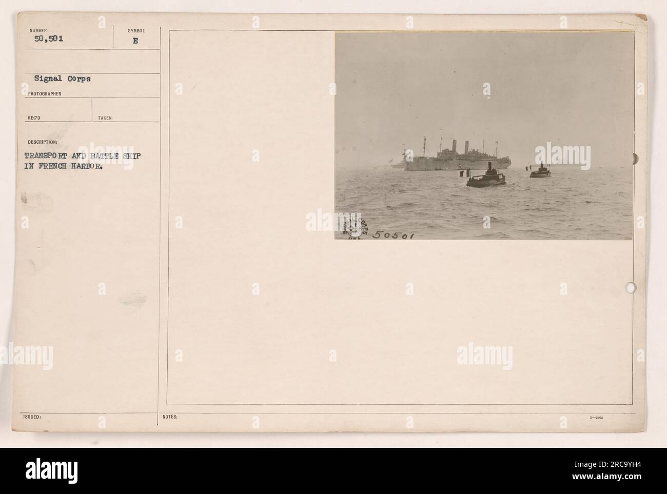 A transport ship and a battle ship rest in a French harbor in 1918 ...