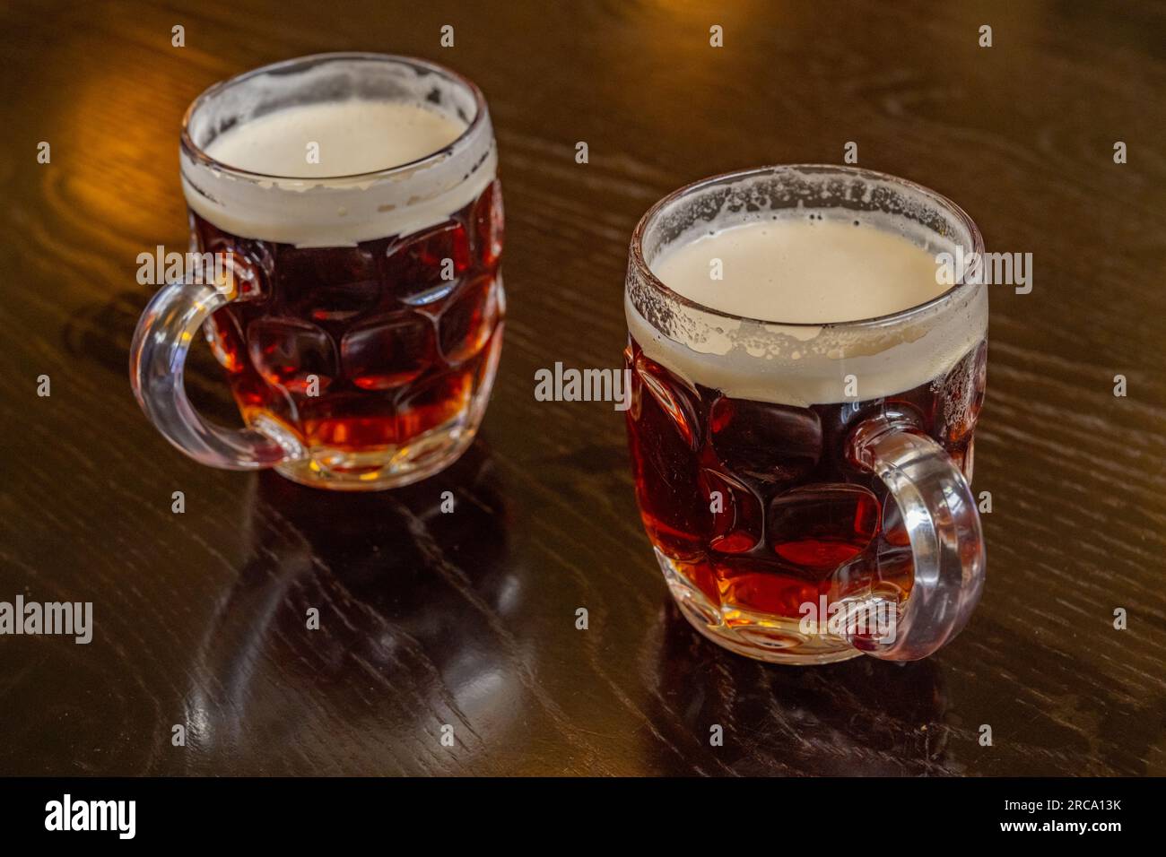 2 half pints off Banks mild beer on a polished wood table Stock Photo ...