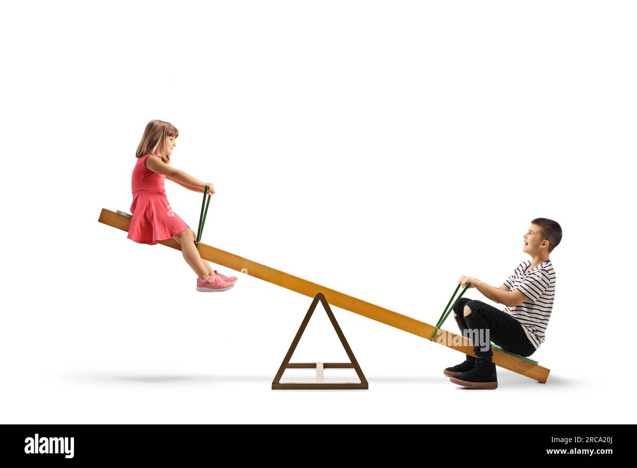 Little girl playing on a seesaw with an older boy isolated on white ...