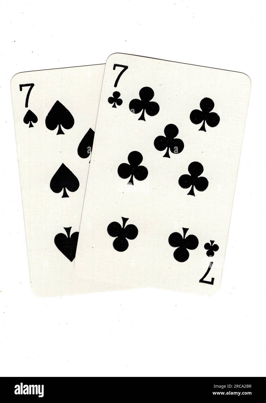 Vintage playing cards showing a pair of black sevens on a white ...