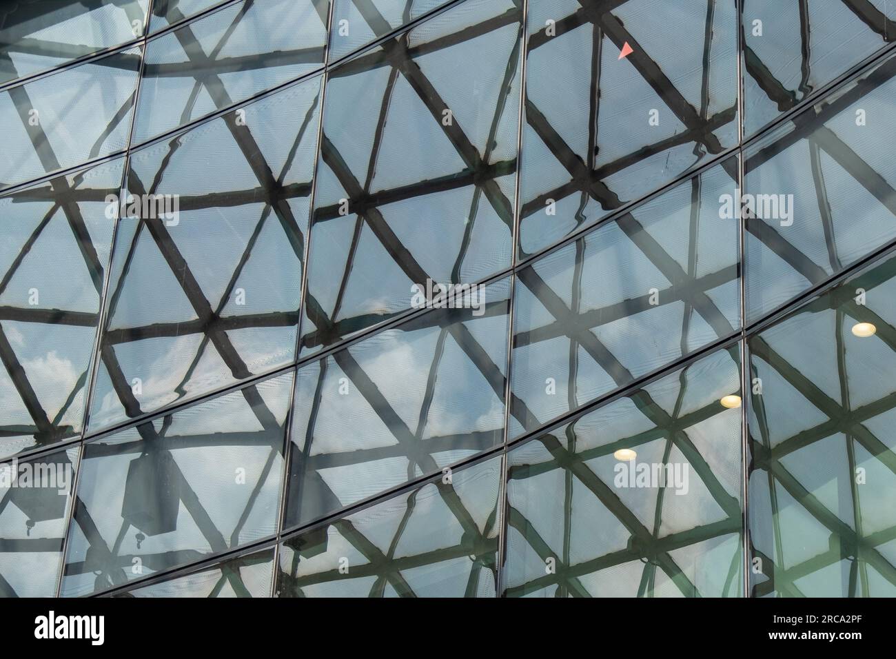 Modern glass facade of building with reflection of roof structure Stock ...