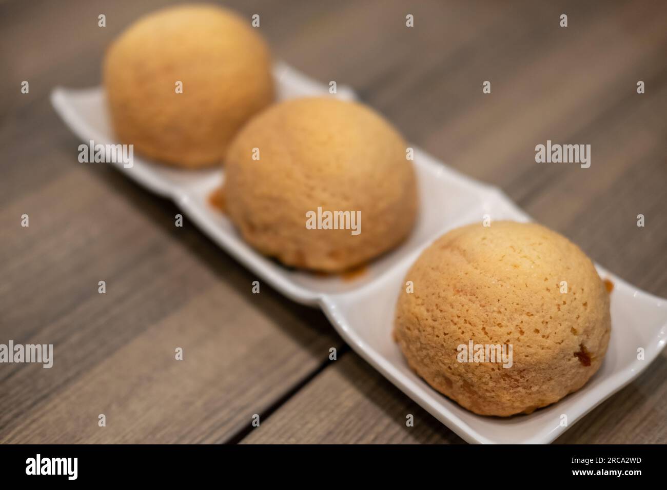 Baked pork buns, Dim Sum served on plate. Chinese food Stock Photo - Alamy
