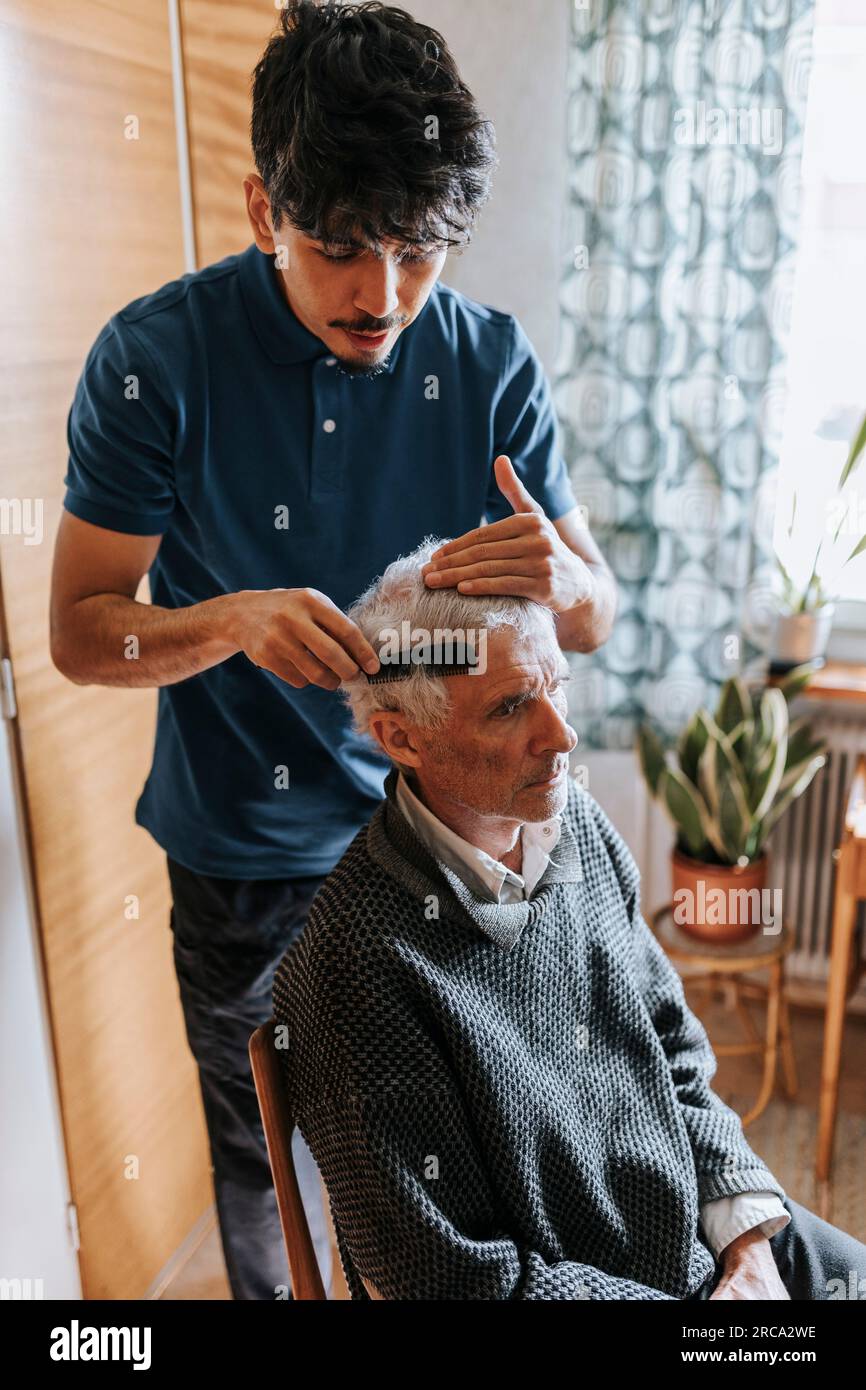 Senior man combing hair hi-res stock photography and images - Alamy