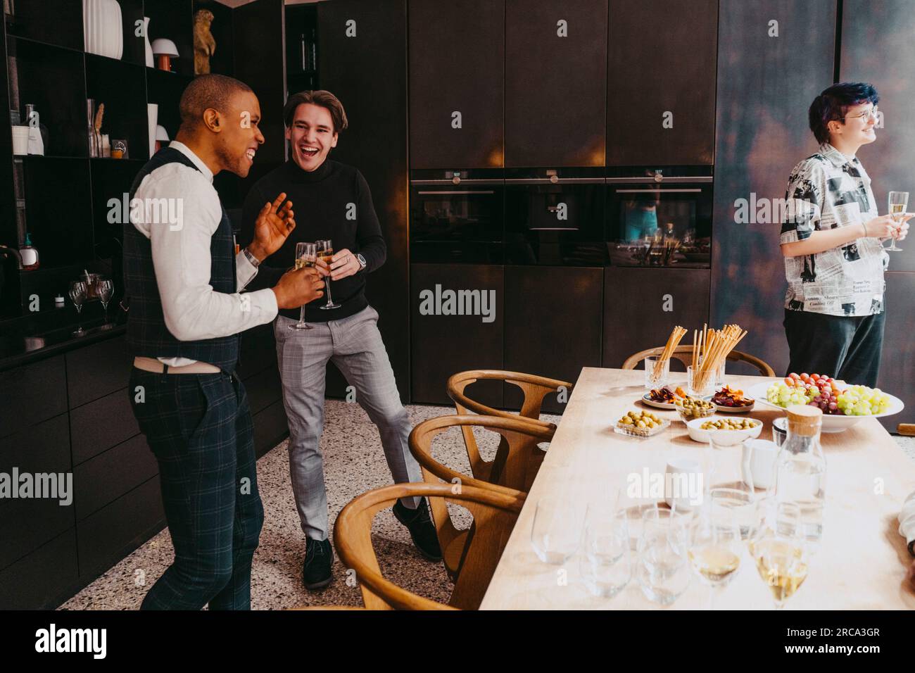 Happy male business colleagues enjoying drinks during during event at ...