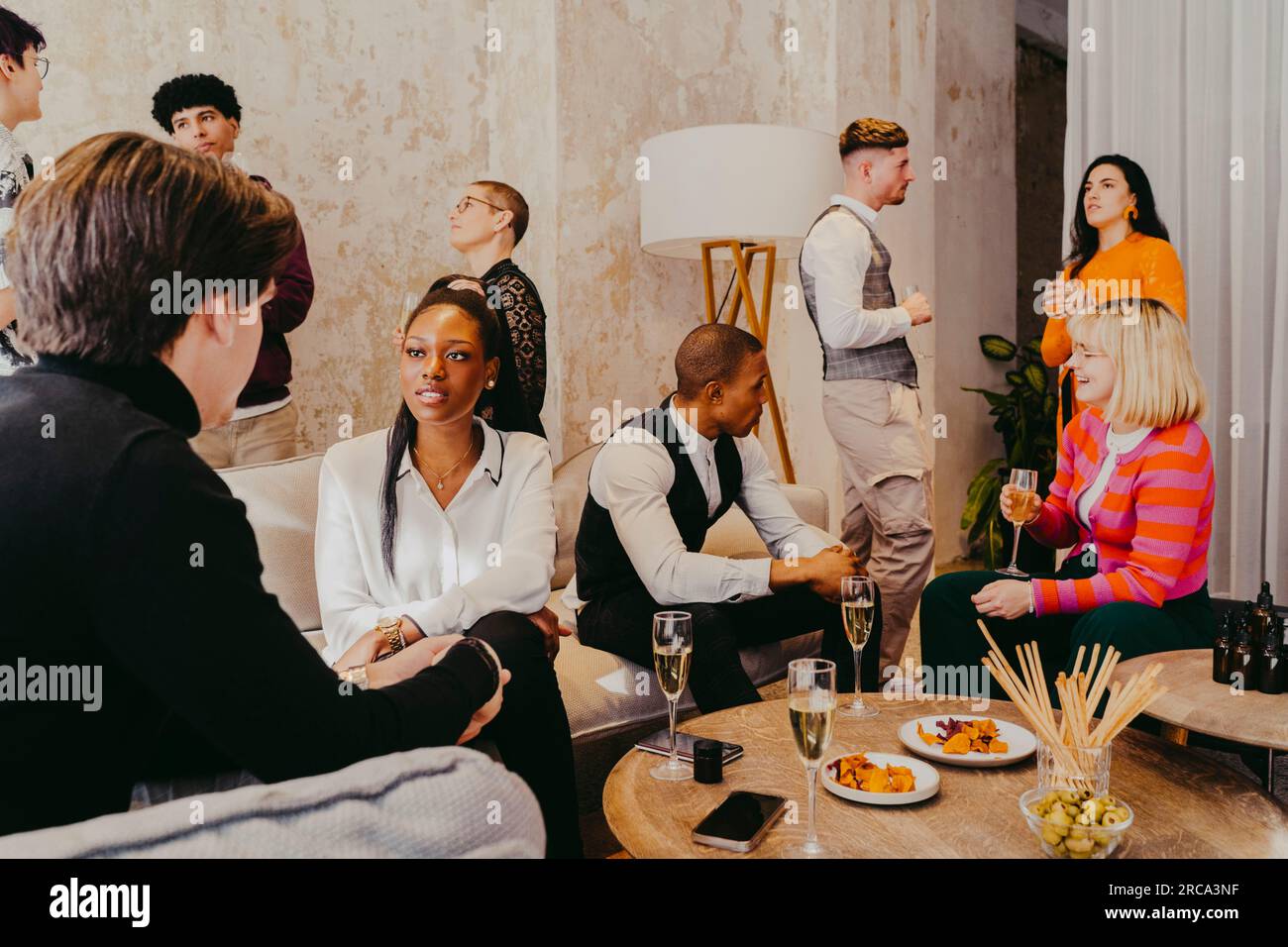 Business colleagues discussing with each other while having food and ...