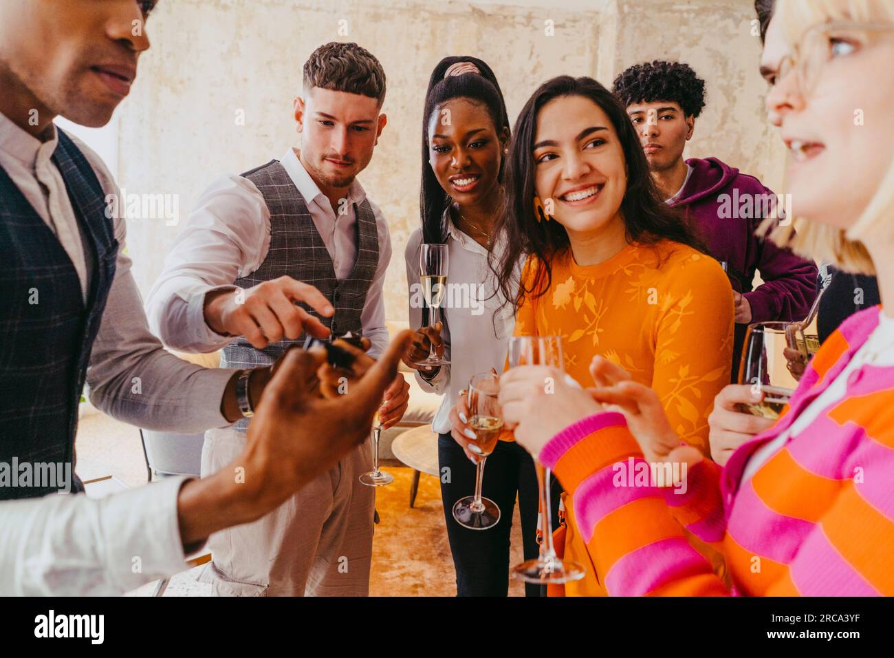 Smiling male and female business colleagues having fun during event at ...