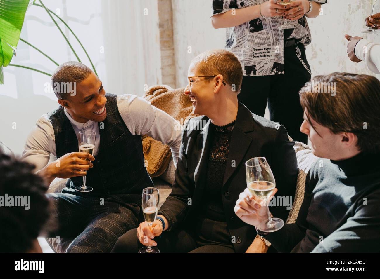 Happy business colleagues enjoying together while having drinks during ...