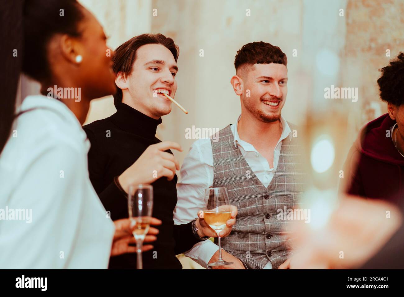 Happy business colleagues enjoying drinks during event at convention ...