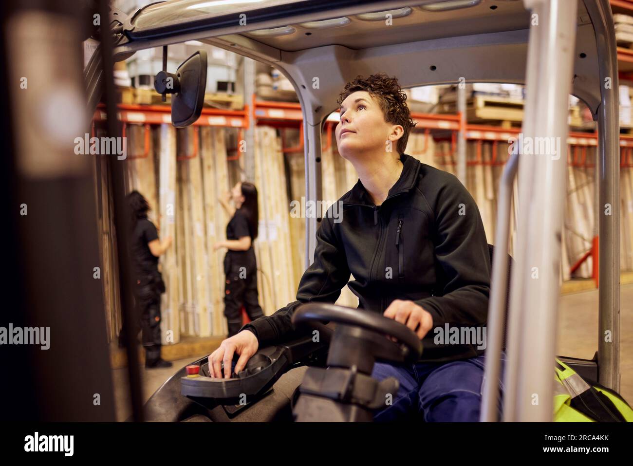 Female forklift operator working in lumber industry Stock Photo - Alamy