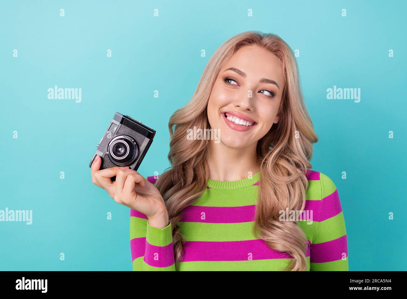 Photo of cunning tricky woman curly hairstyle dressed striped ...