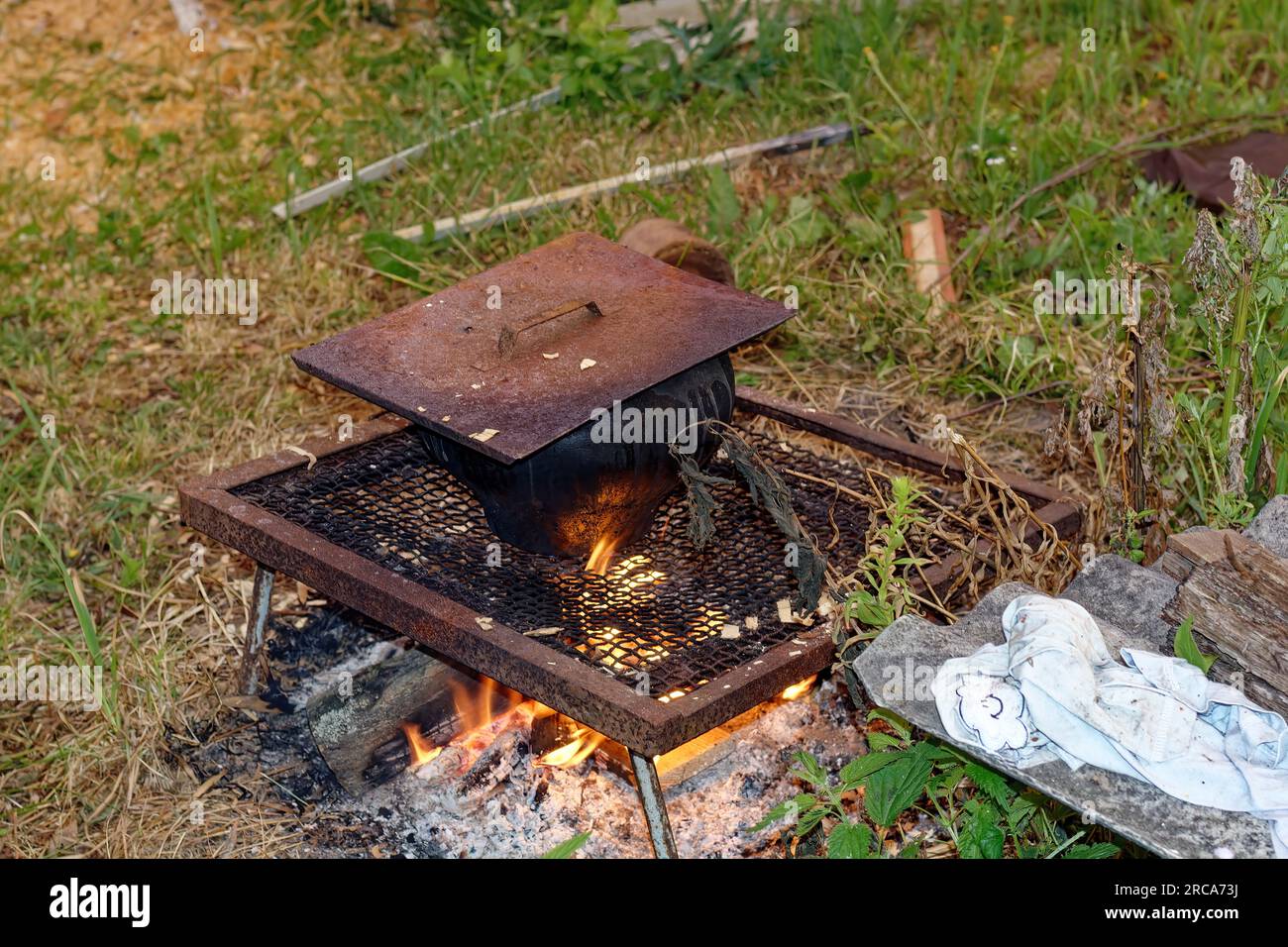Cooking on a fire in cast iron, russia Stock Photo - Alamy