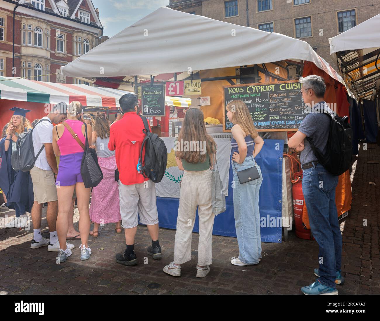 Customers queue at a street food stall (cypriot cuisine) at the Market ...