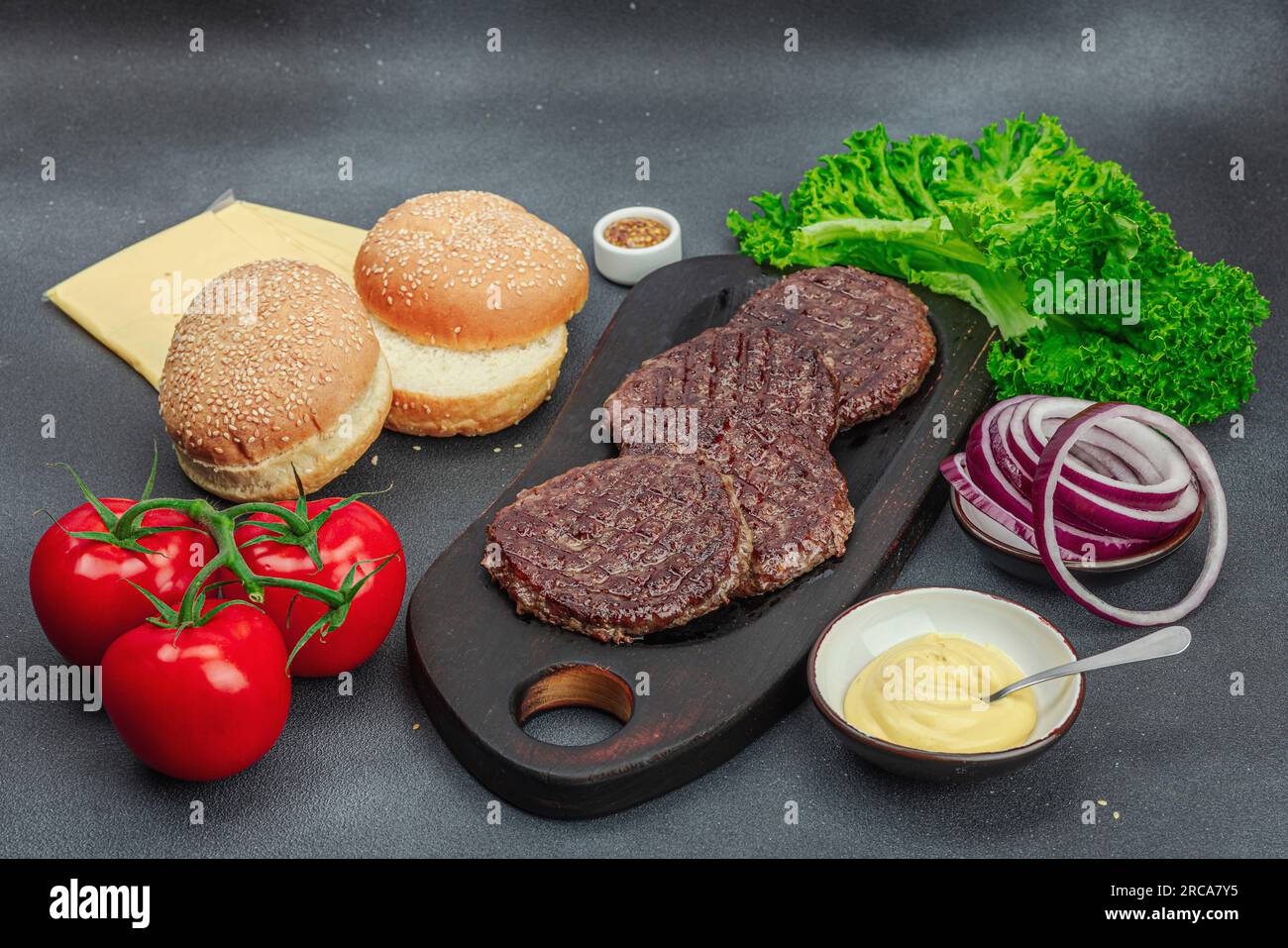 Grilled burger patties. Hot beef cutlets, buns, vegetables and sauce ...
