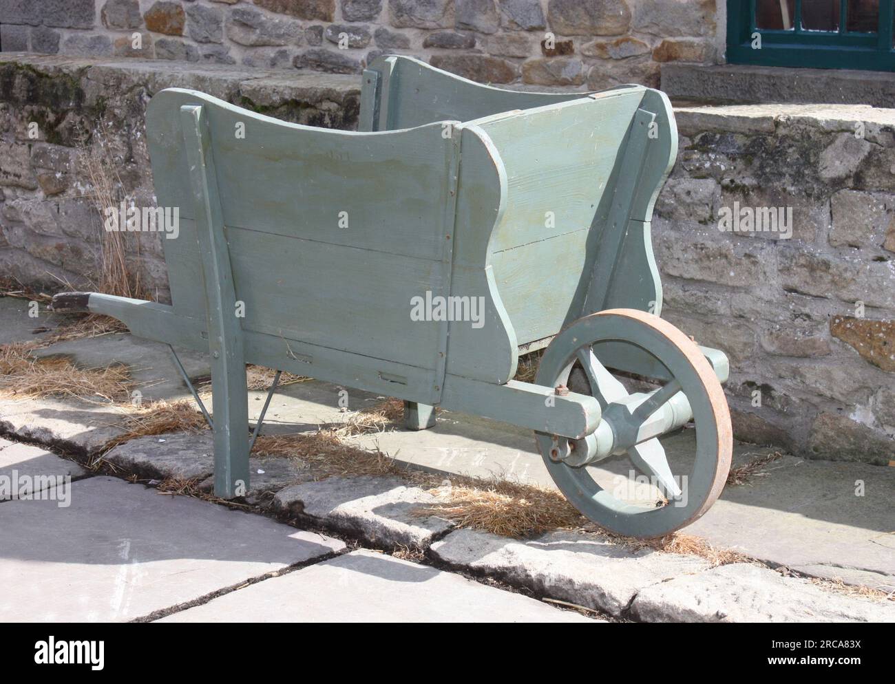 A Deep Wooden Wheelbarrow in a Stone Farmyard Stock Photo - Alamy