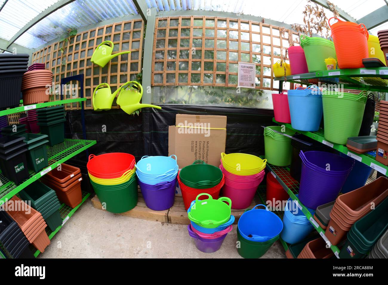 Colourful pots, watering cans, buckets and trugs in garden centre Stock Photo - Alamy