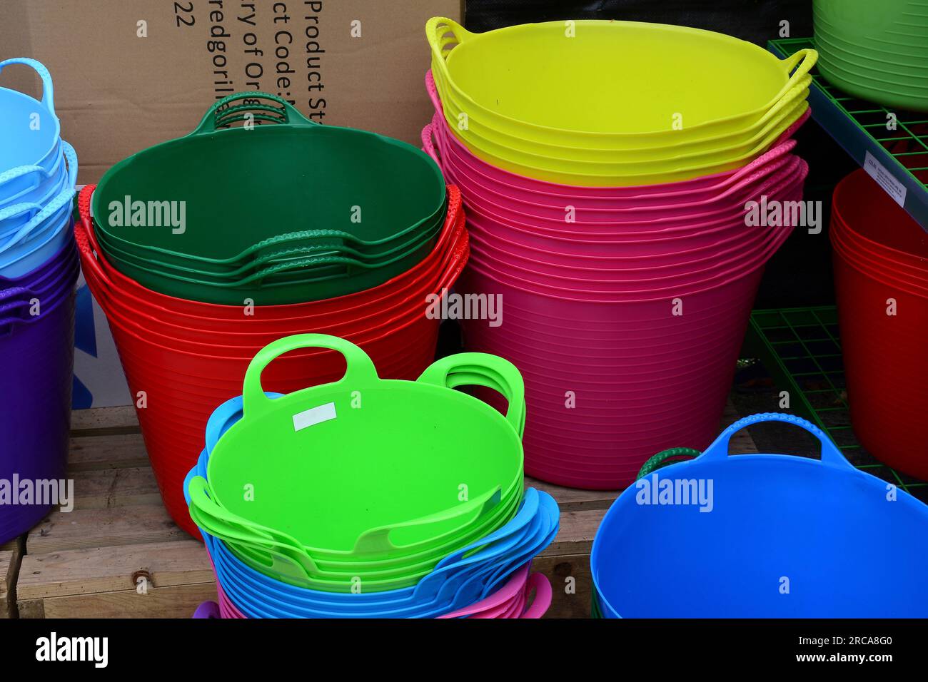 Colourful buckets and trugs in garden centre Stock Photo - Alamy