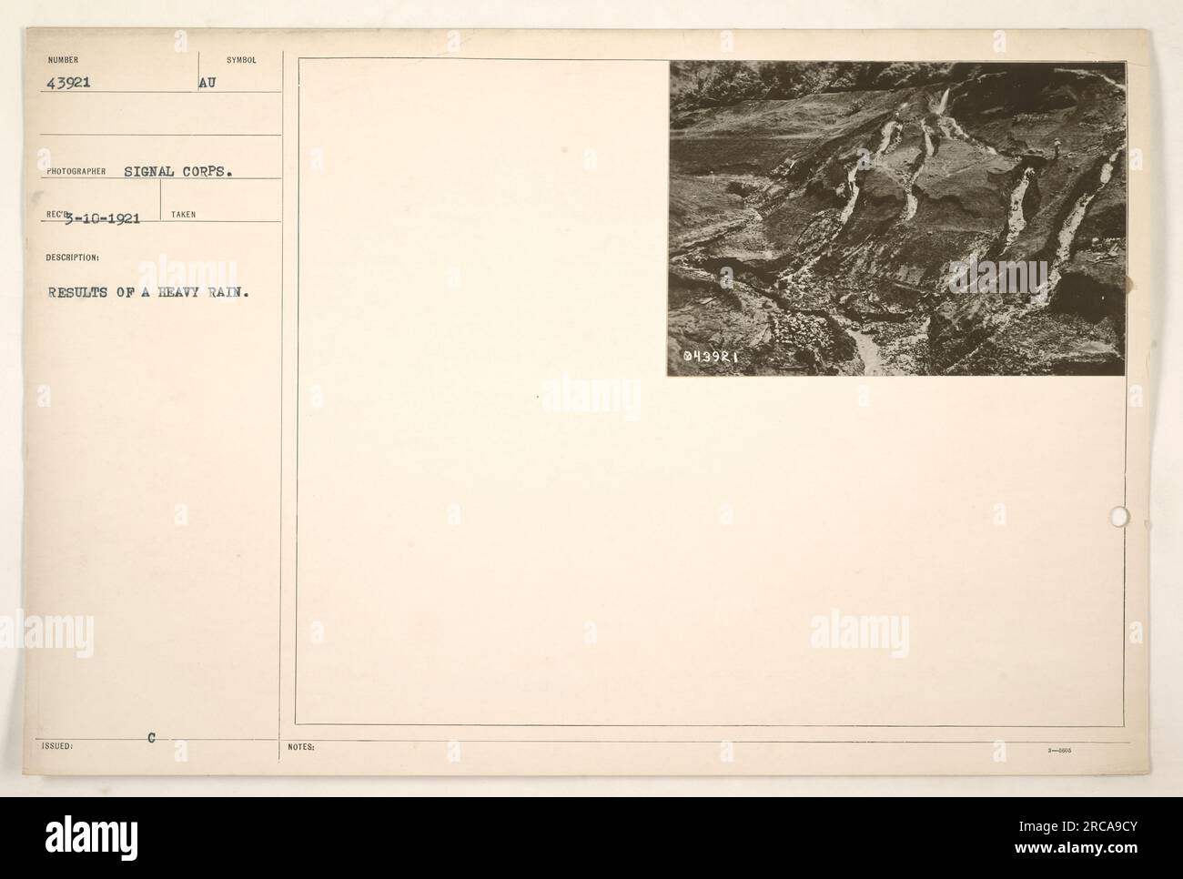 American soldiers walking through a muddy field after a heavy rain. The ...