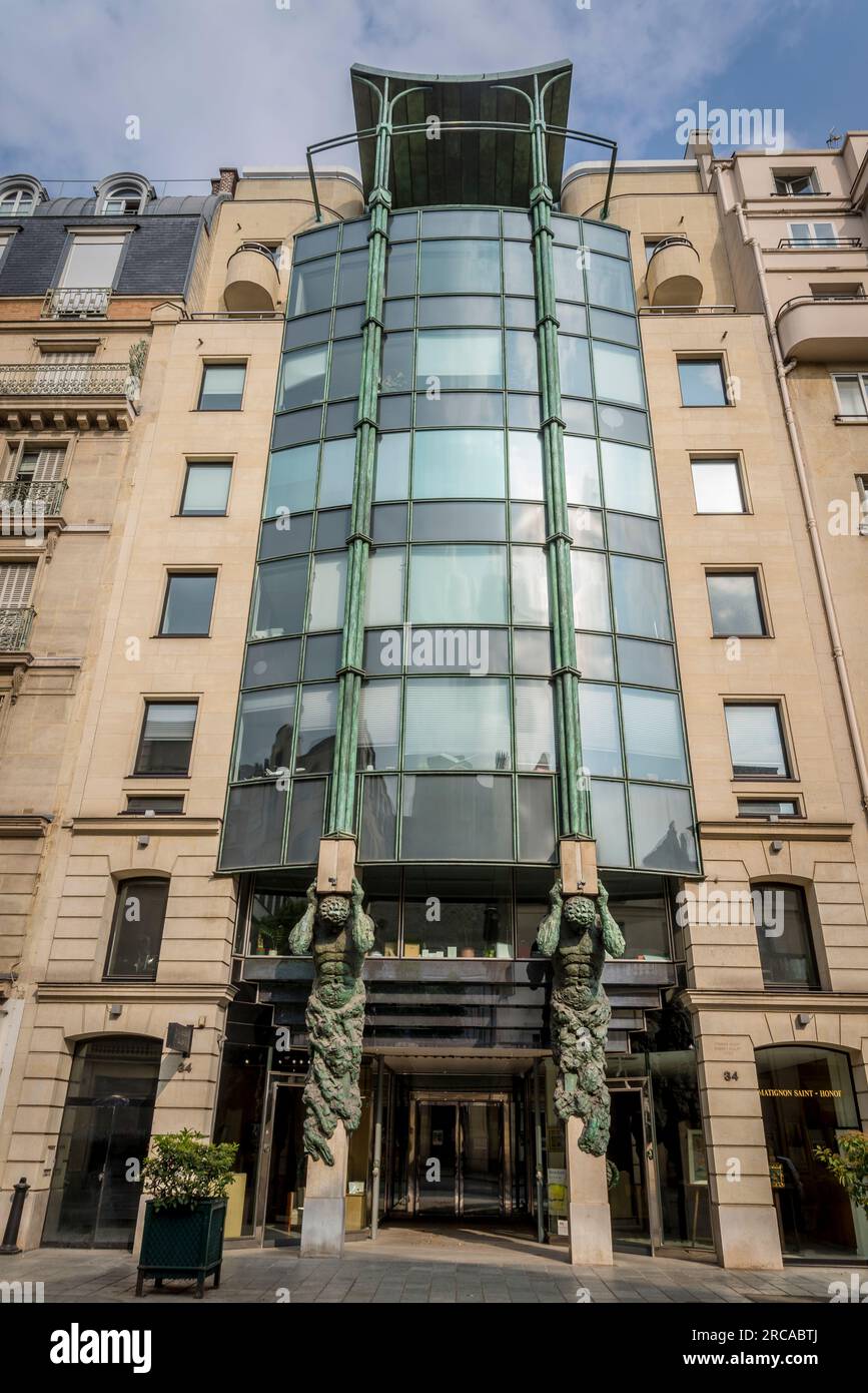 Traditional caryatids supporting a modern glass building, Avenue ...
