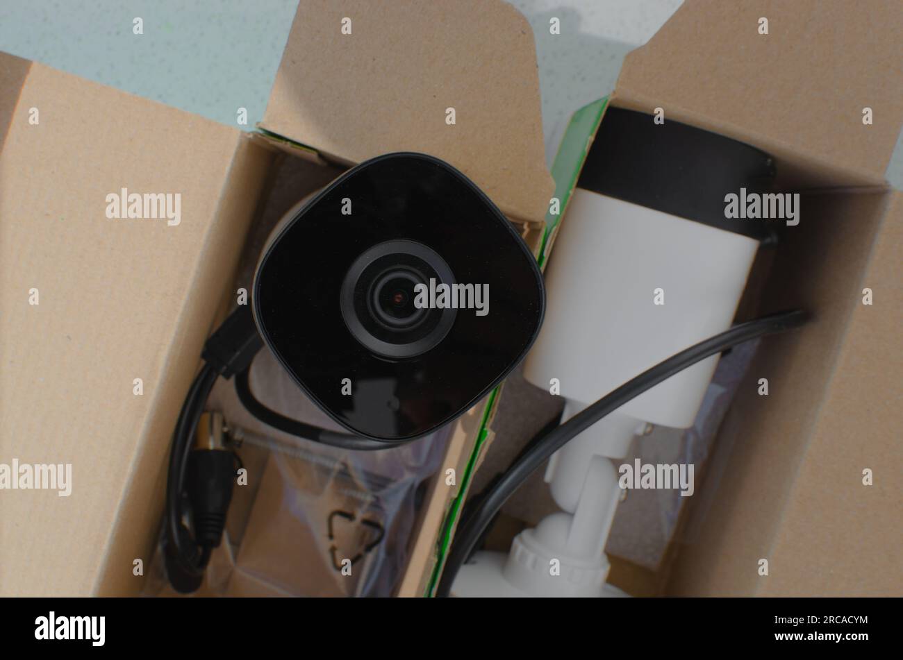 Close-up of black and white security cameras, still in their packaging ...