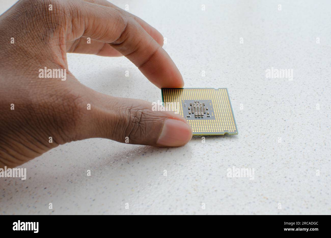 Firm hand holding a high-performance processor, symbolizing evolution ...