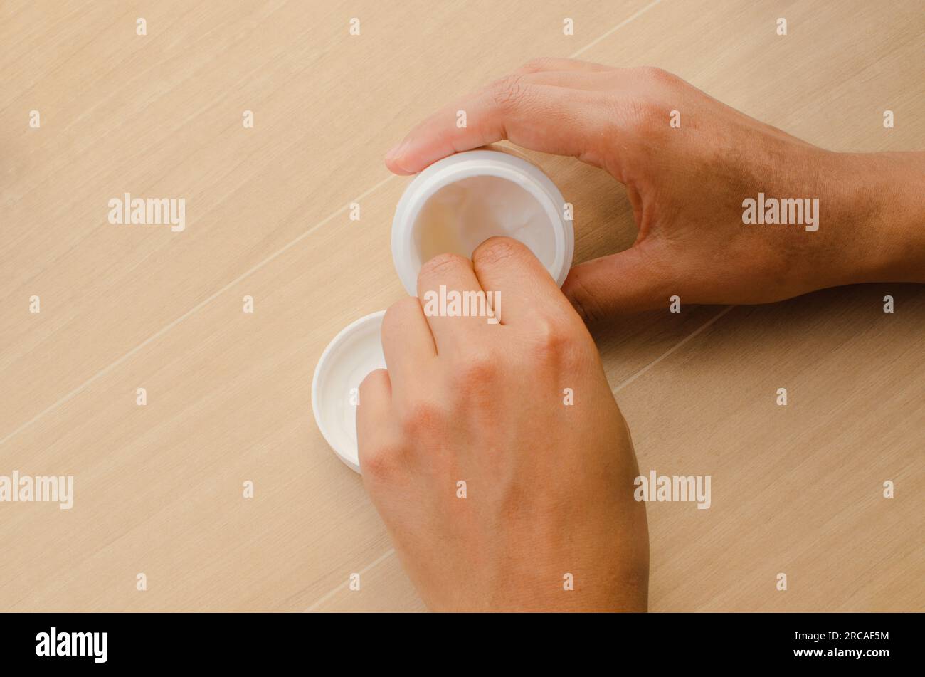 Touching softness: close-up on hands massaging a skin cream in a ...