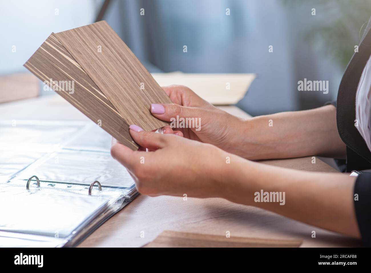 Choice of floor color. A woman chooses a shade of wood floor color ...