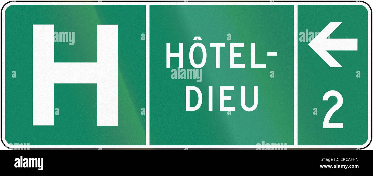 Guide sign in Quebec, Canada - Hospital on the left. The text means ...