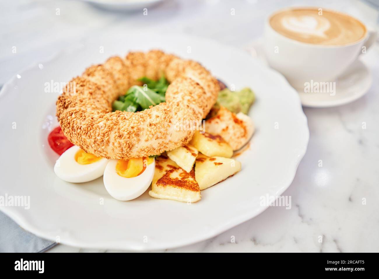 Turkish breakfast with simit, cheese, tomato, cucumber, olives ...