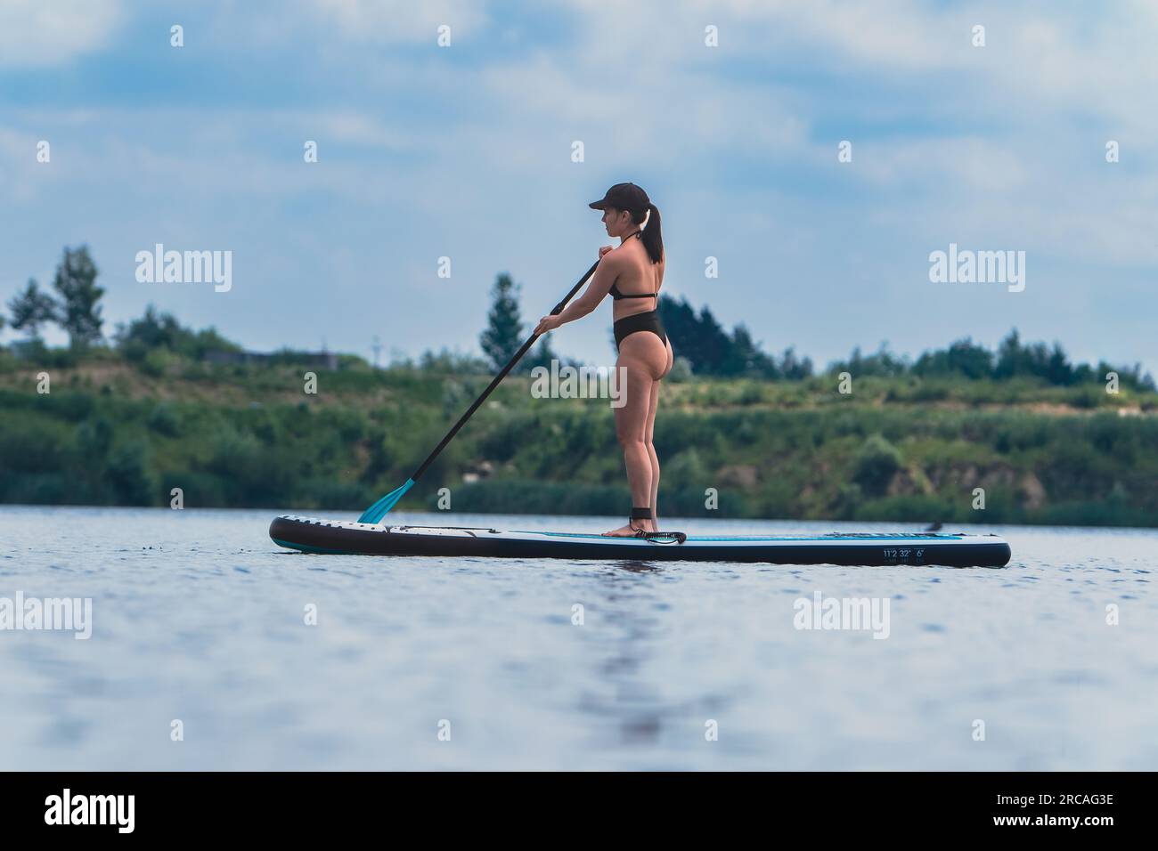 standing woman on supboard Stock Photo - Alamy