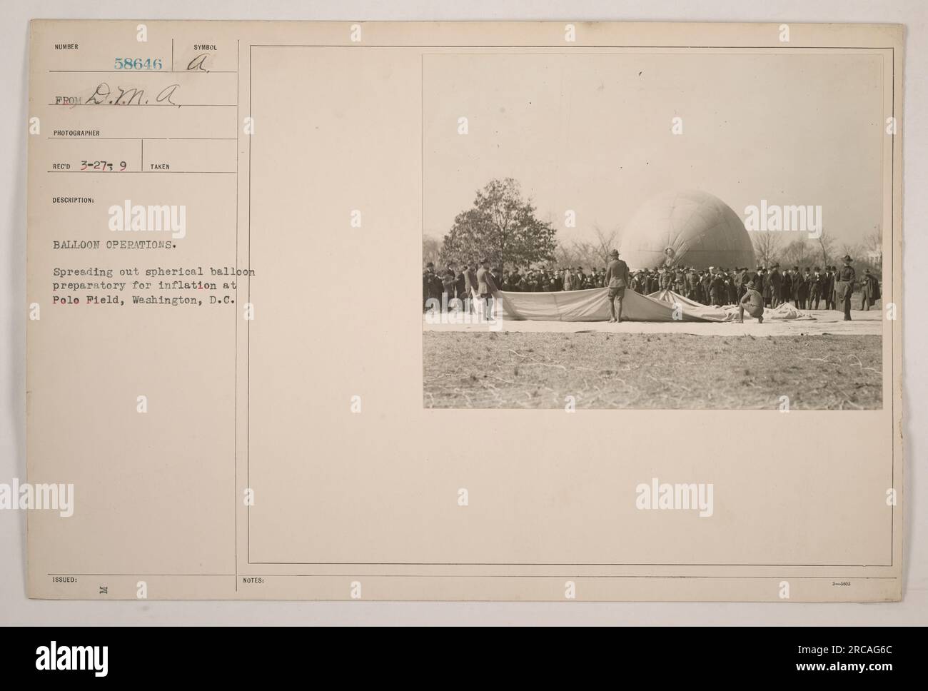 Soldiers prepping a spherical balloon for inflation at Polo Field ...