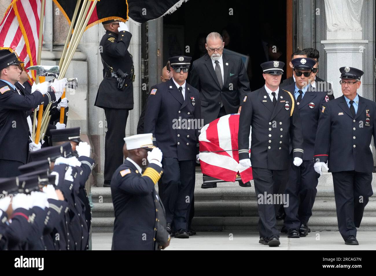 The casket of Newark firefighter Augusto "Augie" Acabou is carried from ...