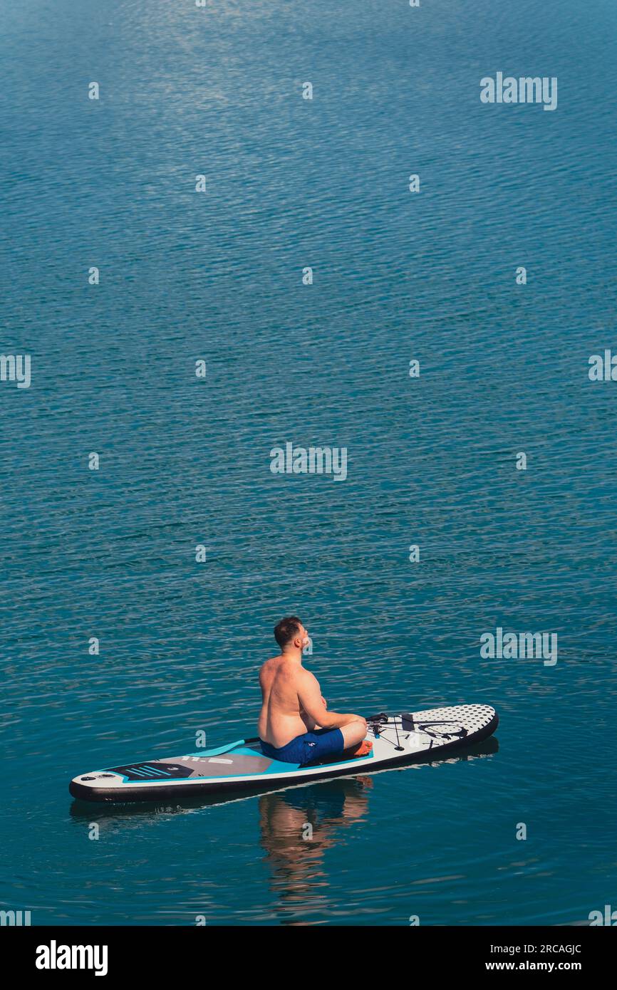 man on paddleboard in the middle of the lake Stock Photo - Alamy