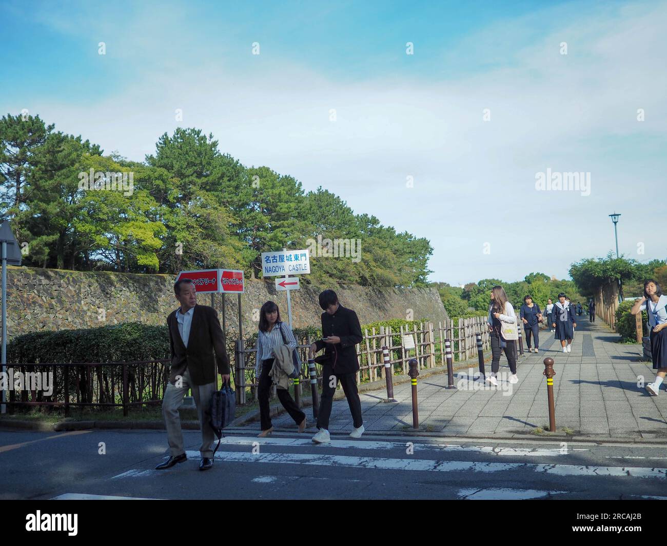 Japanese people around Nagoya castle crossing the street in sunny day ...