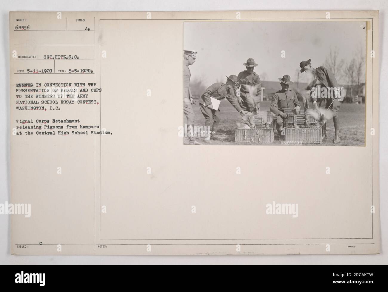 Signal Corps detachment releasing pigeons from hampers at Central High ...