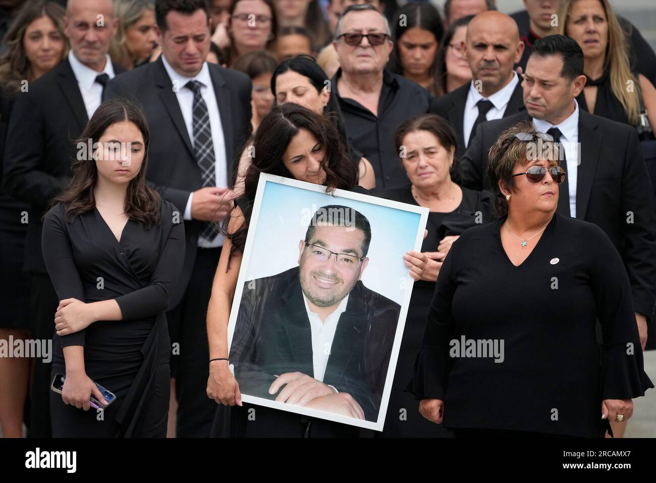 Family and close friends walk before the casket of Newark firefighter ...