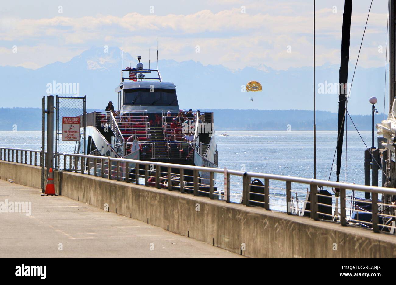 Salish Sea Tours boat Orca One arriving at Pier 57 with a parasail with ...
